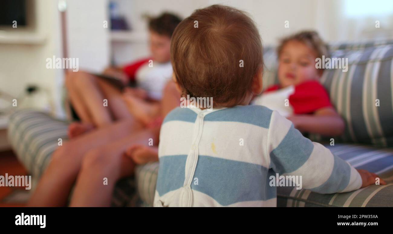 Baby infant interaction with siblings at home, candid and real. Toddler ...