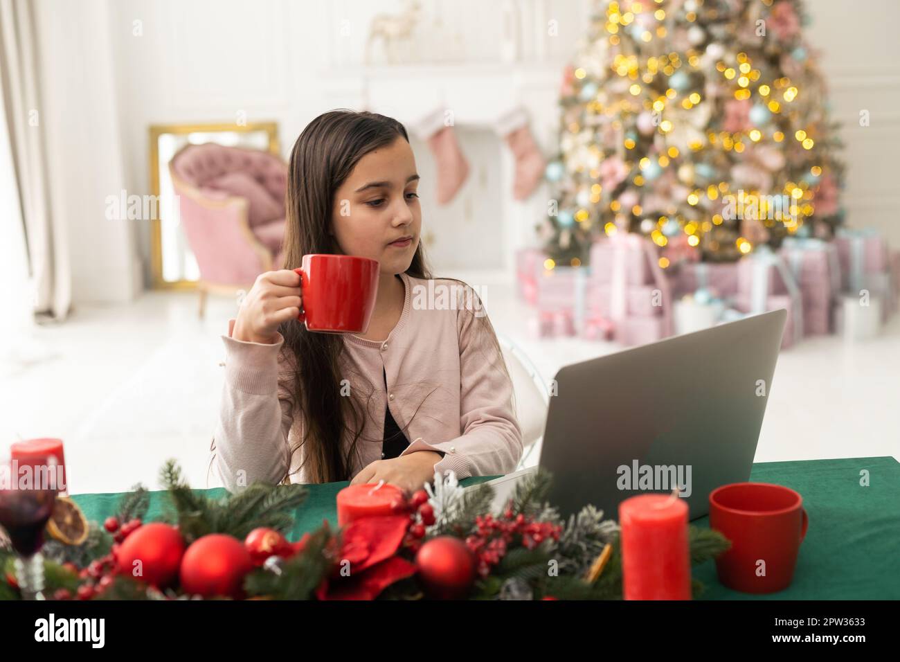 Christmas distance learning online education. Schoolgirl studying at ...
