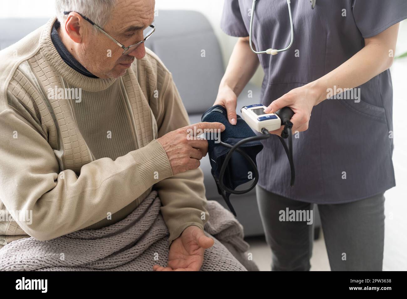 Young woman doctor wearing white uniform with stethoscope checking ...