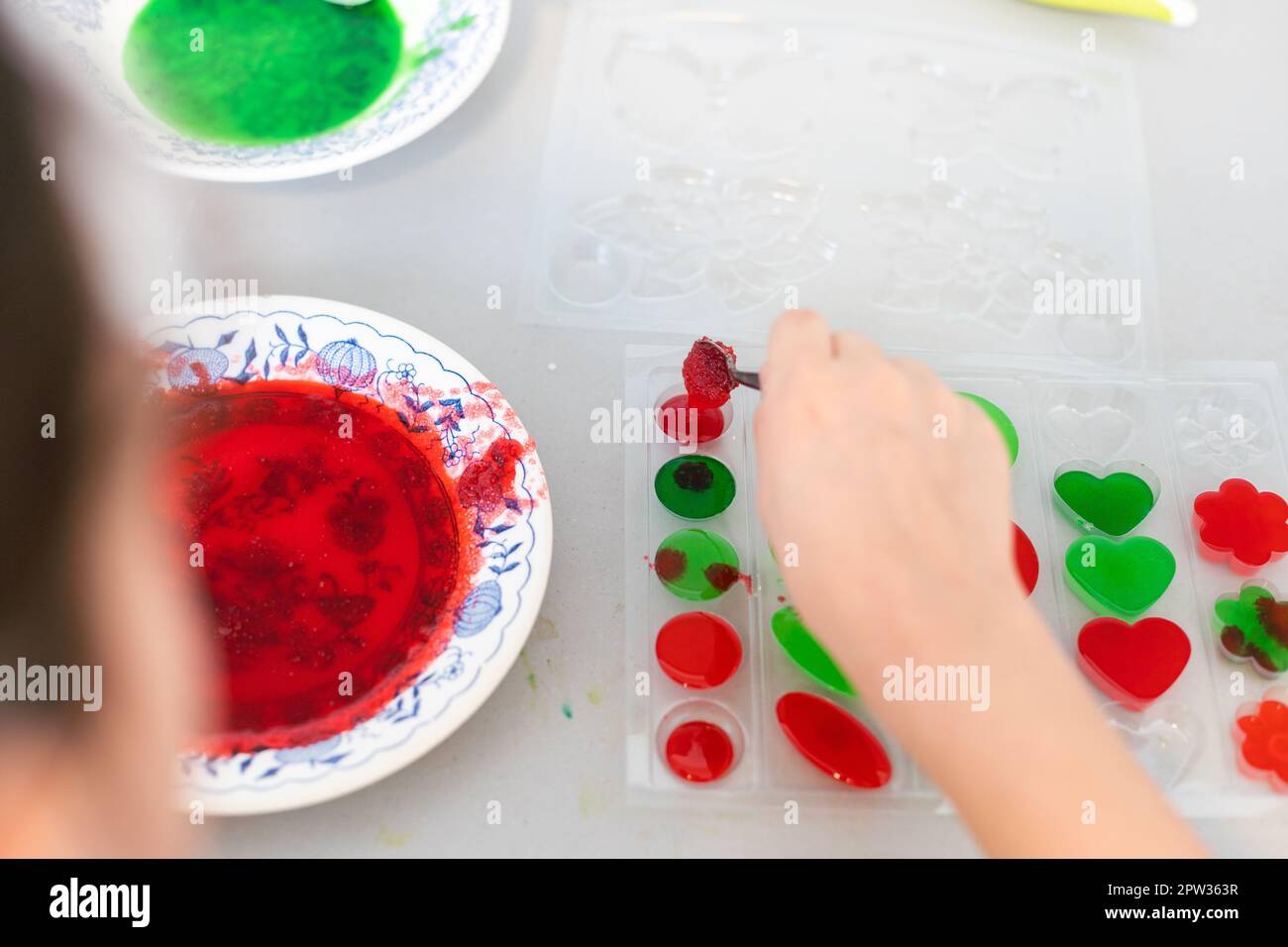 Enthusiastic little girl doing home science project, having a eureka ...