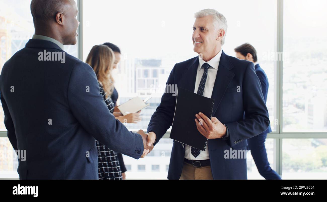 We can do so much when we work together. two businesspeople shaking ...