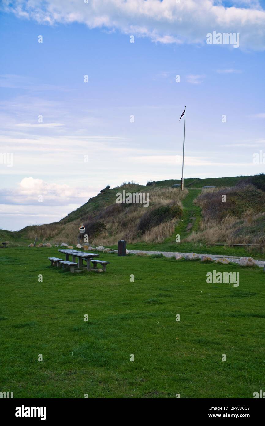 Hundested, Denmark picnic place in front of the cliffs. Flagpole with ...