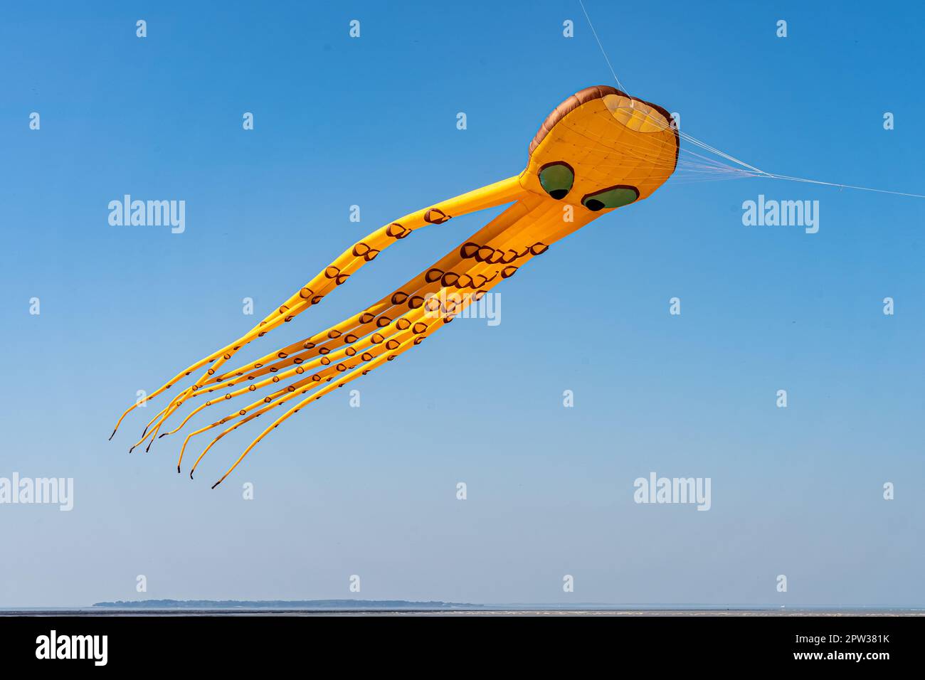 orange octopus kite flying on the blue sky in the kite festival Stock ...