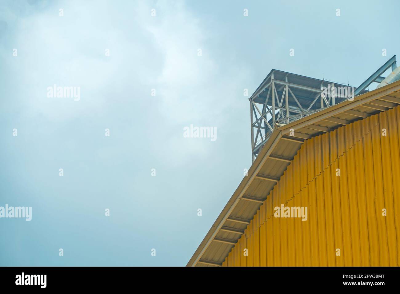 Factory of yellow wall building on blue sky Stock Photo - Alamy