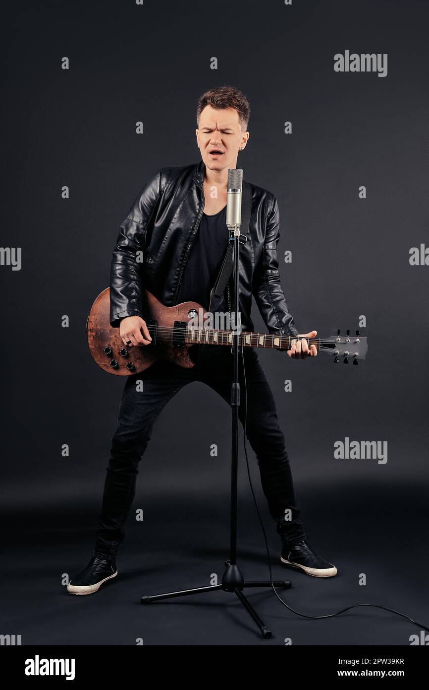 Full length portrait of artist playing guitar Stock Photo - Alamy
