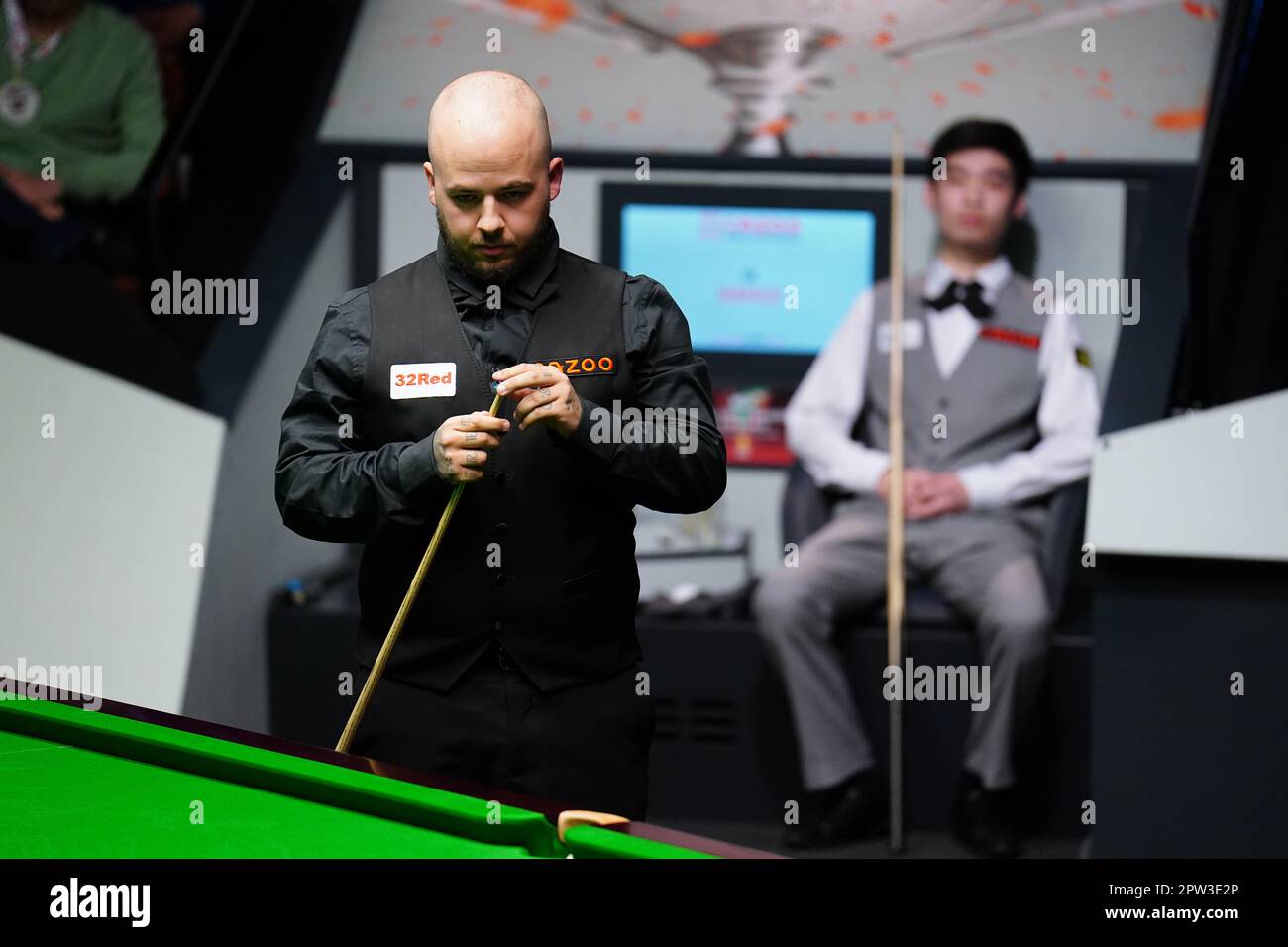 Luca Brecel in action against Si Jiahui (right) on day fourteen of the ...