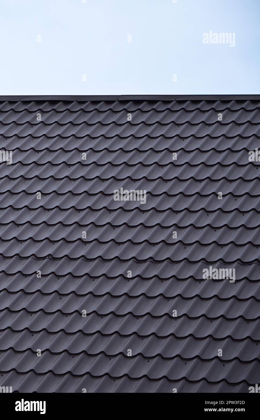 The texture of the roof of painted metal. Close-up detailed view of ...