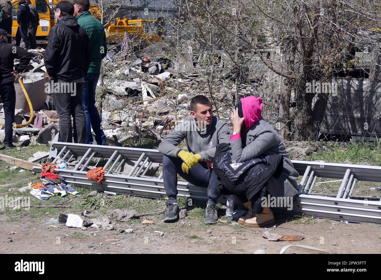 UMAN, UKRAINE - APRIL 28, 2023 - People sit on a telescopic ladder ...