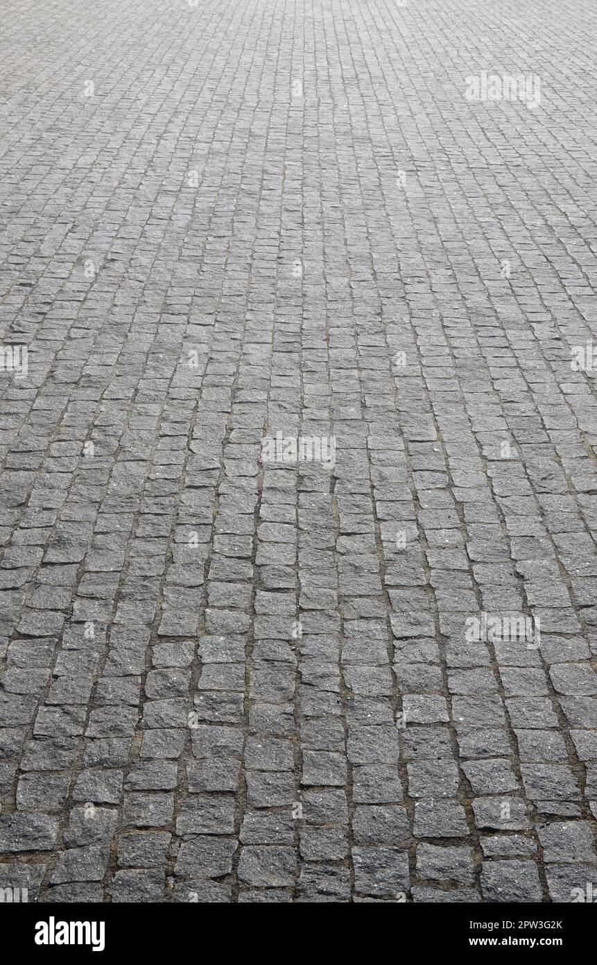 The texture of the paving slab (paving stones) of many small stones of ...