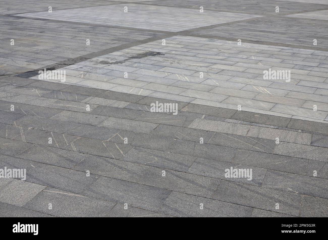 The texture of granite paving tiles from a variety of square shaped ...