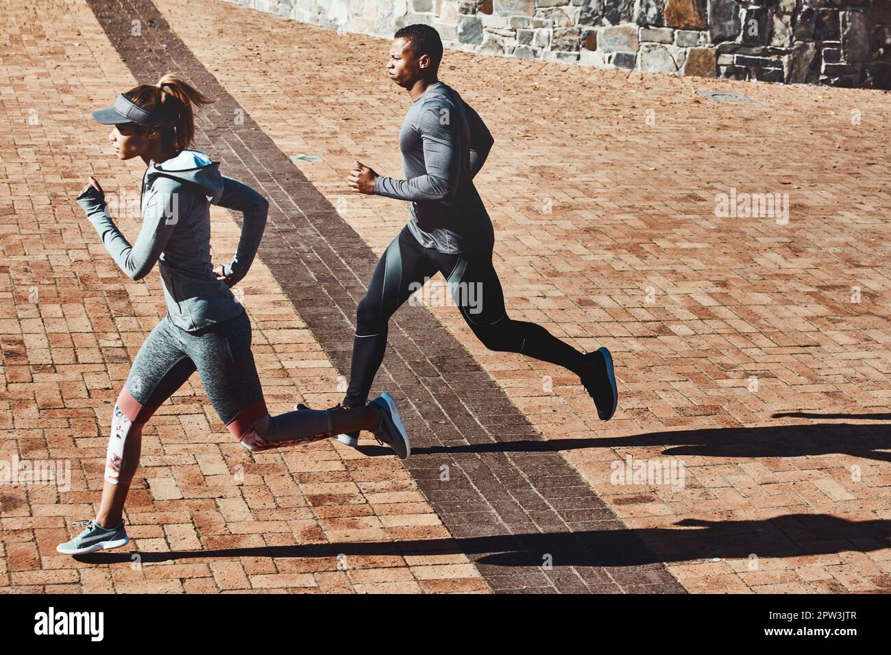 Running together is their thing. Full length shot of two young and ...