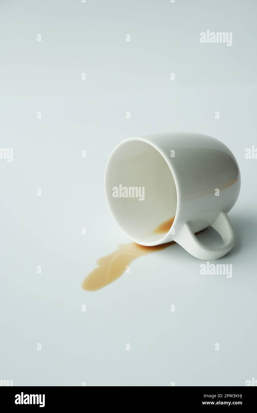 cup of coffee spilled on white background Stock Photo - Alamy