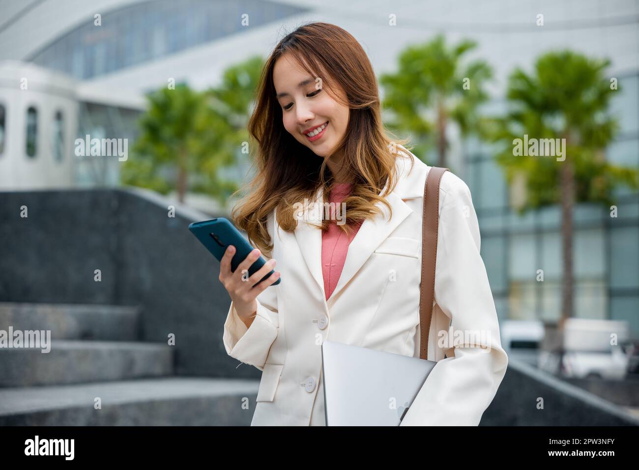 Asian woman successfully work go to against city scene of modern office ...