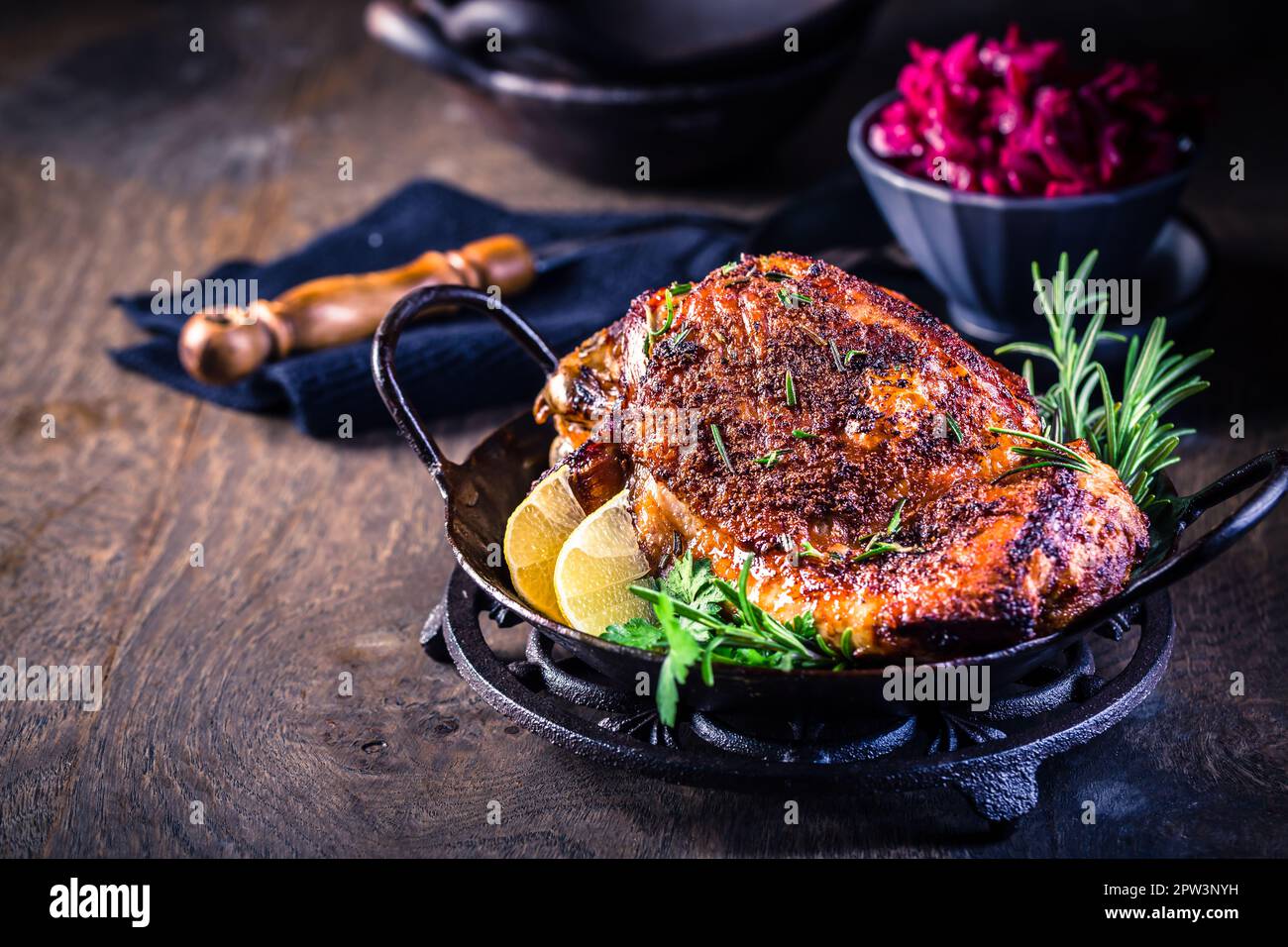 Roasted turkey knuckle with pickled red cabbage salad on wooden ...