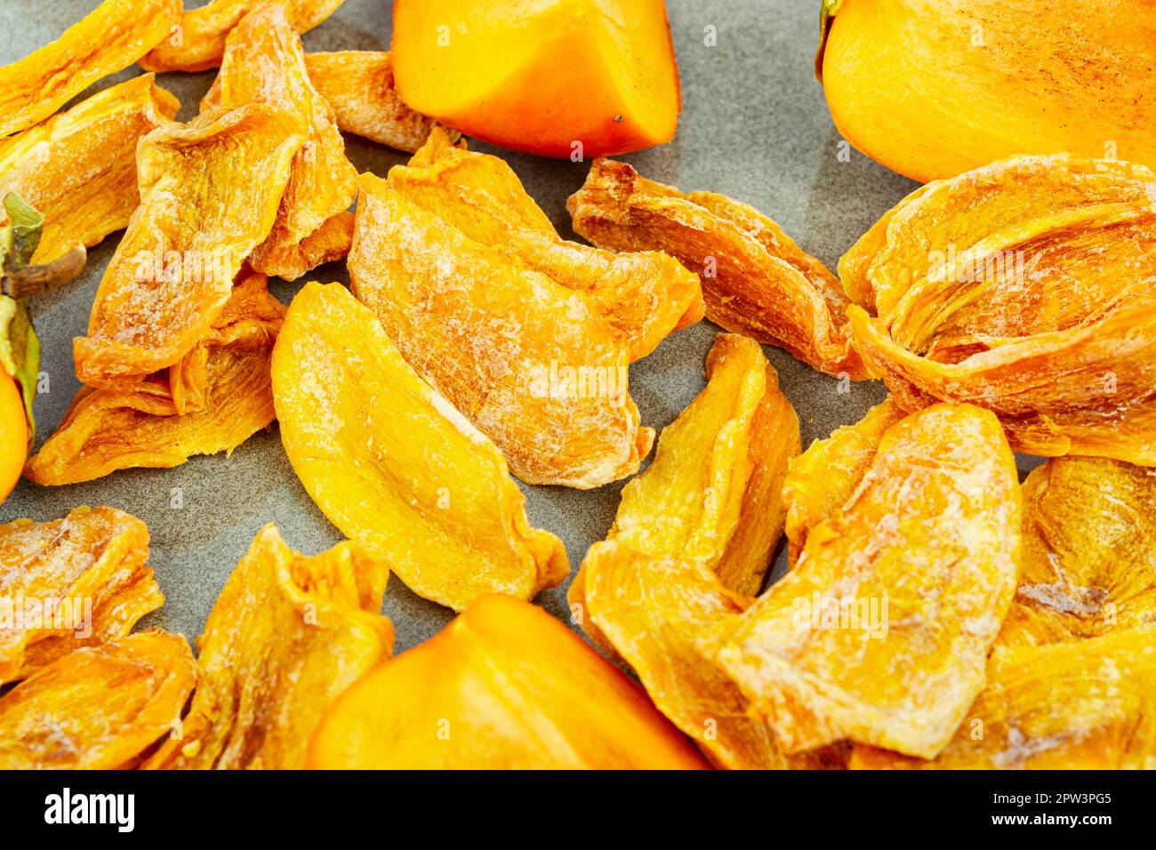 Dried persimmon fruits with fresh persimmon. Vegan snacks Stock Photo ...