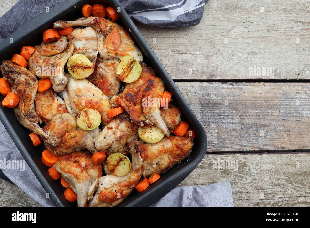 Roasted Rabbit Haunches in Pan with Stewed Vegetables on Rustic Wooden ...