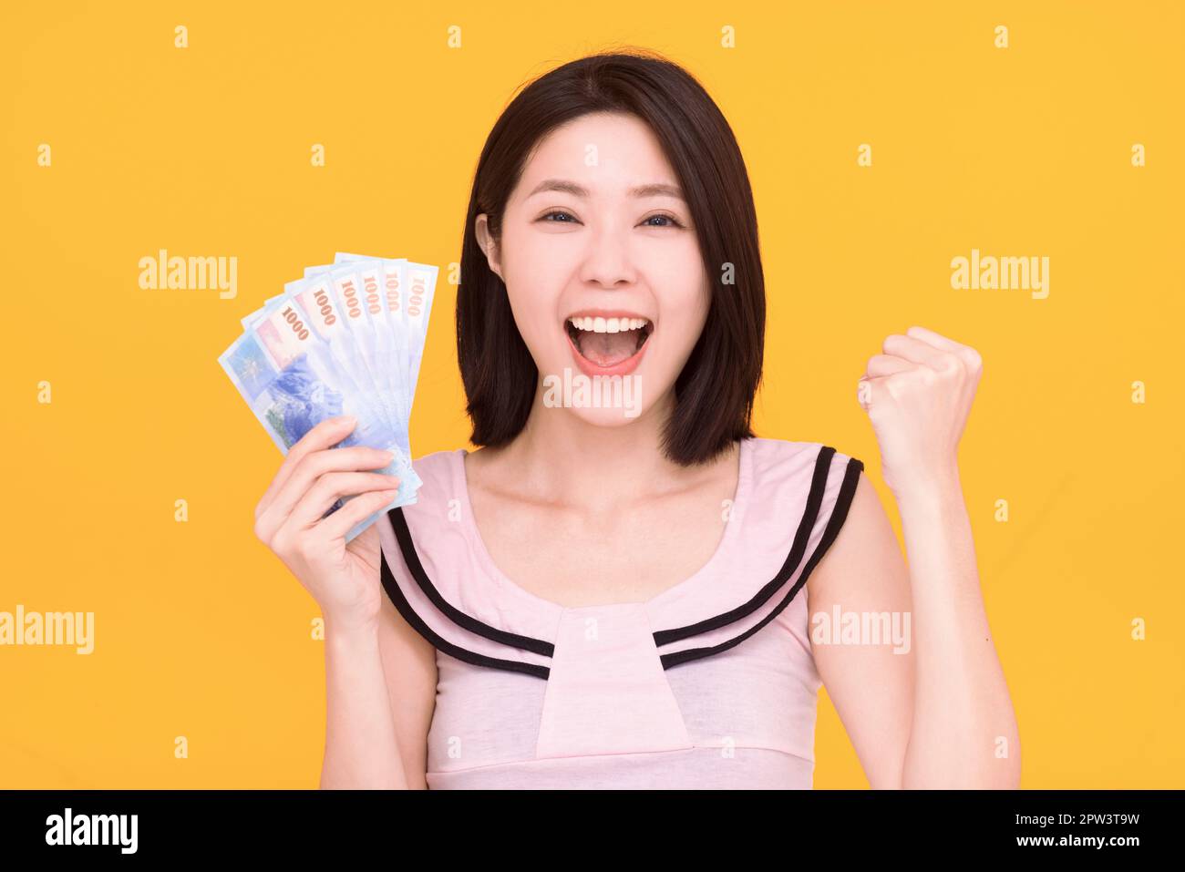 Excited young woman showing the money Stock Photo - Alamy