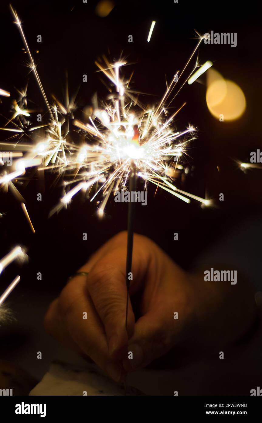 A sparkling sparkler at a party or New Year's Eve Stock Photo - Alamy