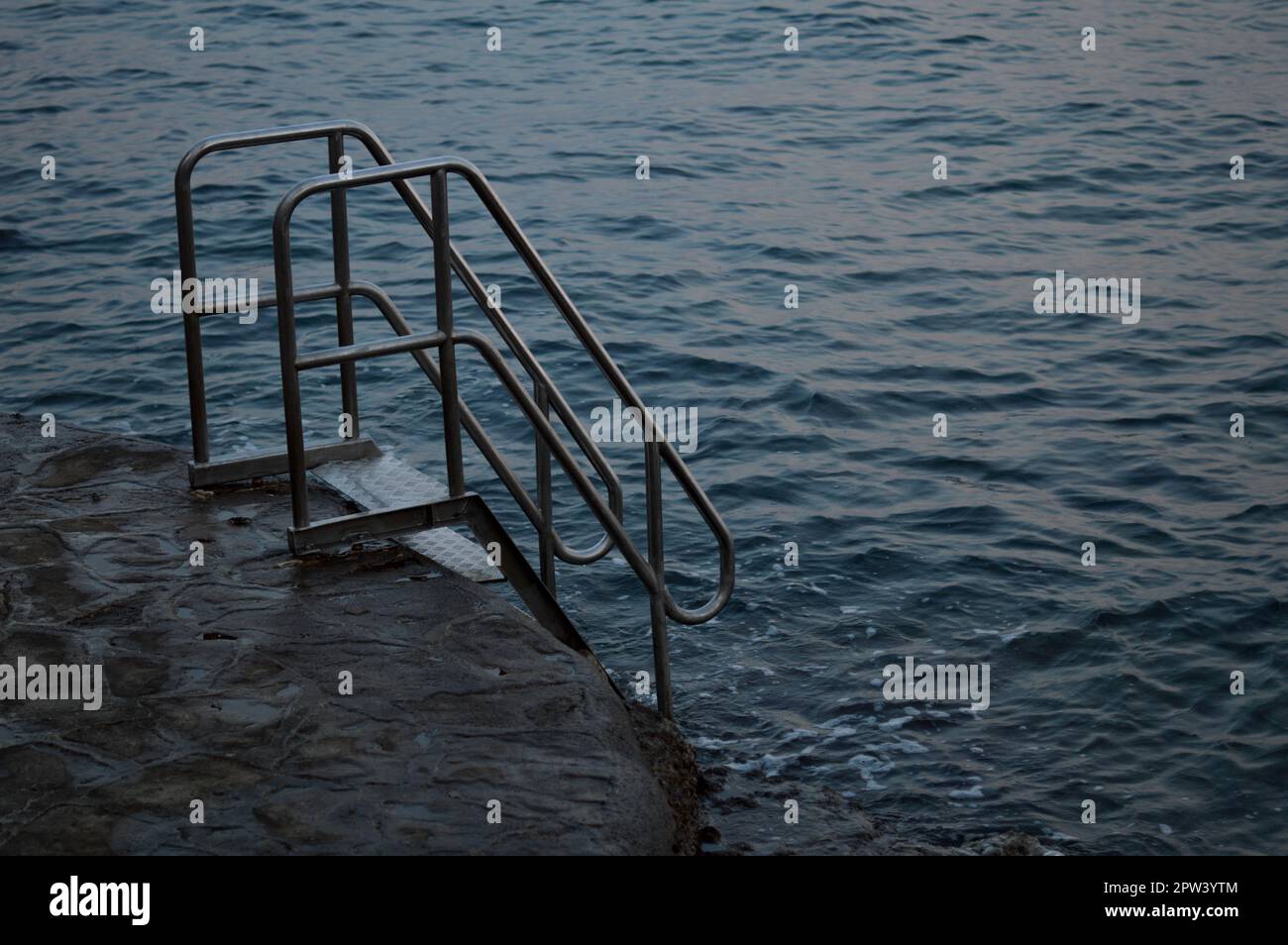 Railing at the beach, metal railing in the water, sea water Stock Photo ...