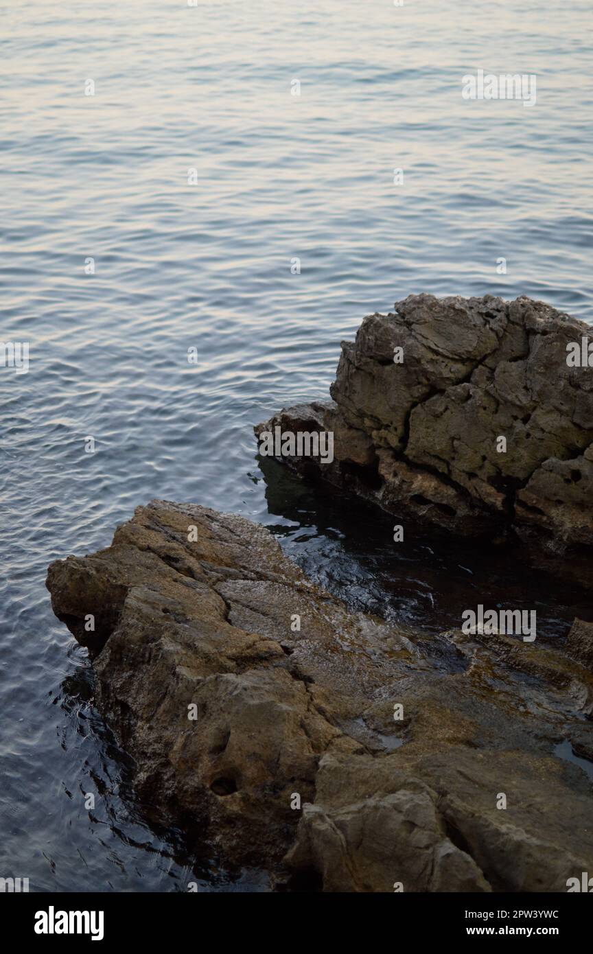 Rocks at the beach, calm water, small waves, clear water Stock Photo ...