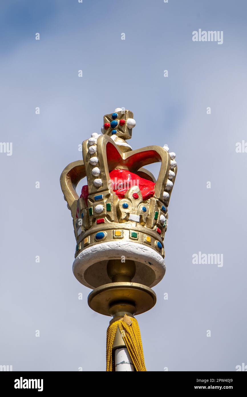 London, UK. 28th April, 2023. Huge painted crowns on top of flag poles ...