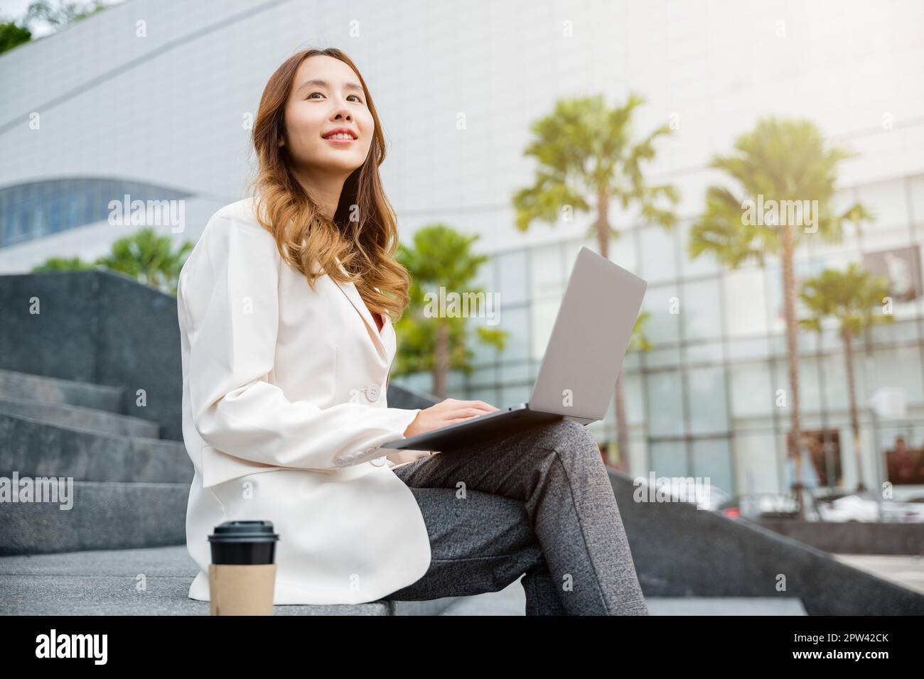 Remote working concept outside the office. Happy young Asian woman ...