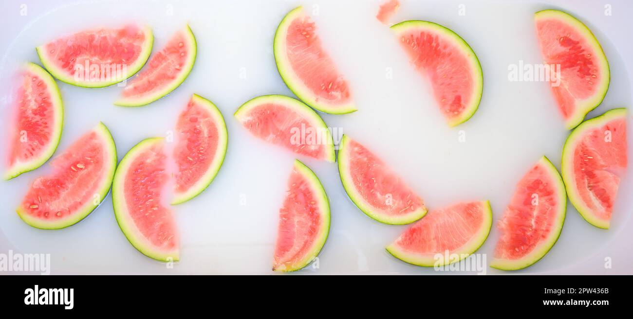Turbid soapy water in bath with slices of watermelon. top view in full ...