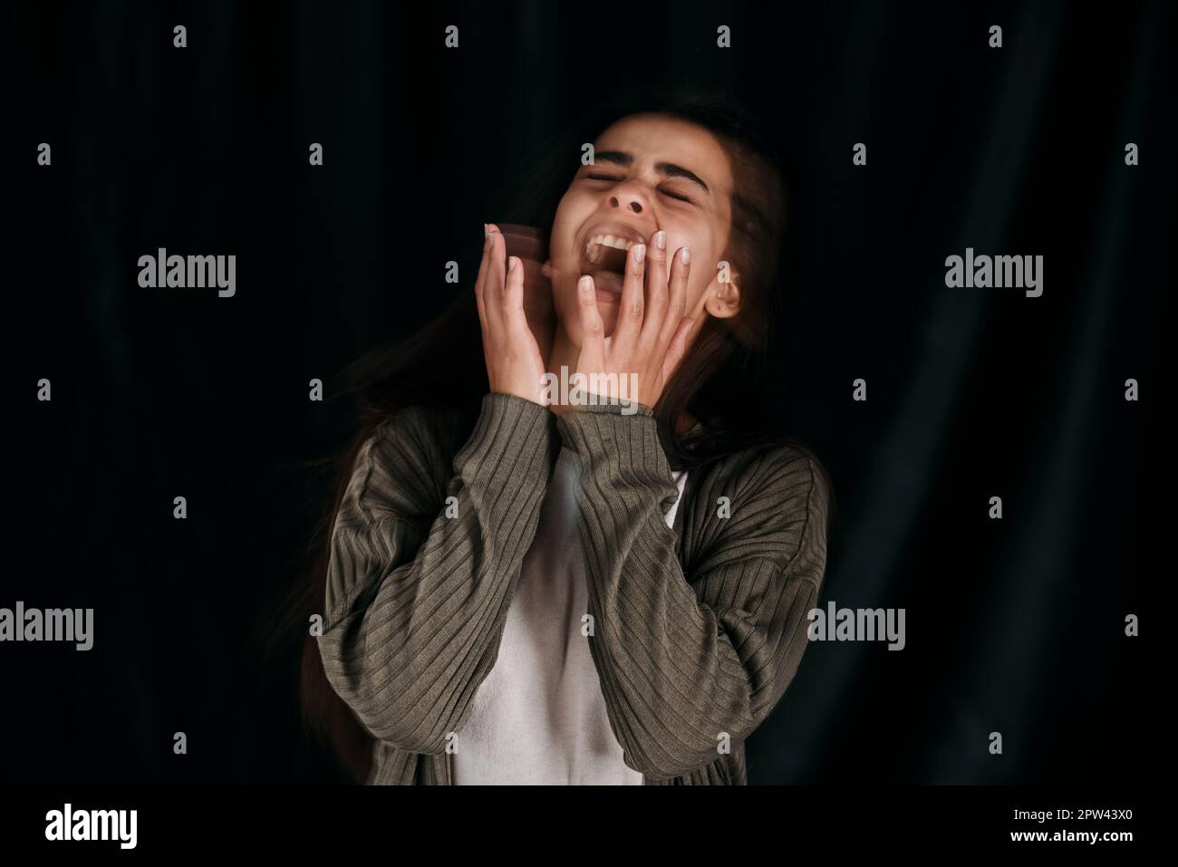Woman, stress or screaming on black background in studio in mental ...