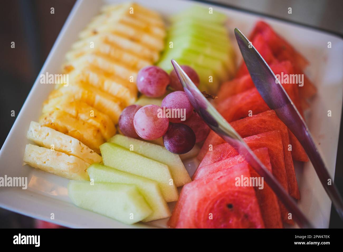Sliced fruit mix on a plate, orange, watermelon, grape Stock Photo - Alamy