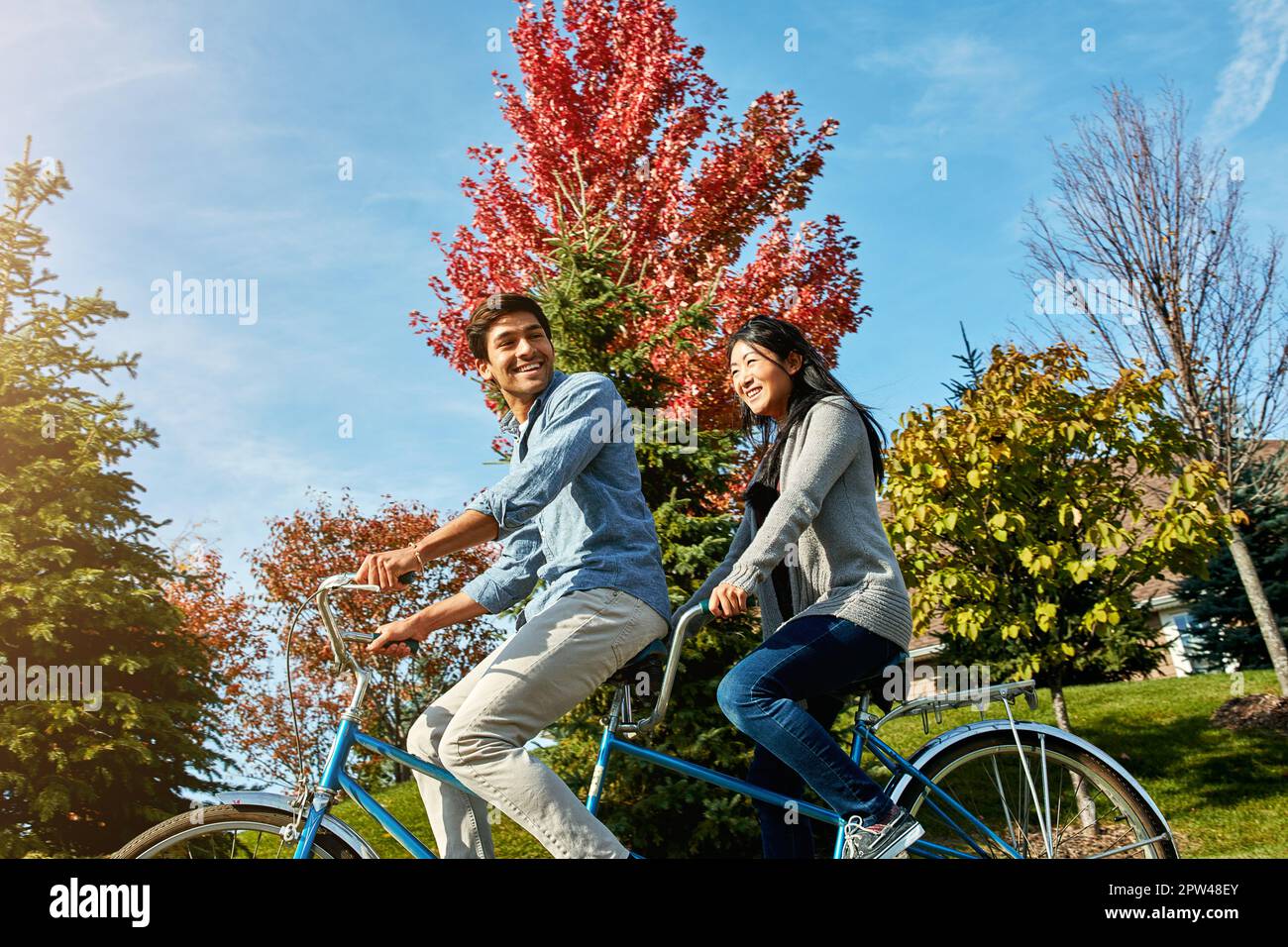 We enjoy the simple things. a young couple out for a ride on a tandem ...