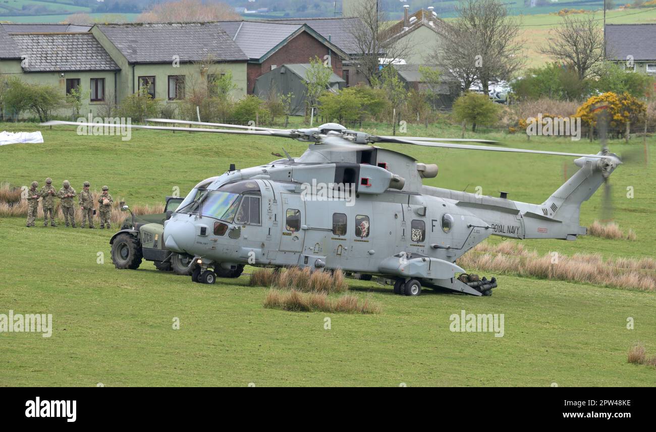 Personell and equiment being loaded onto a Royal Navy Merlin Commando ...