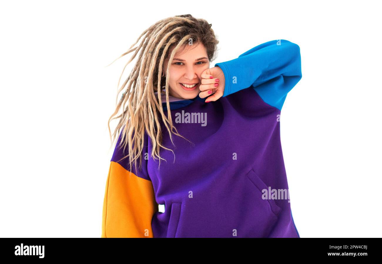 Cheerful young female in colorful outfit looking at camera with smile ...