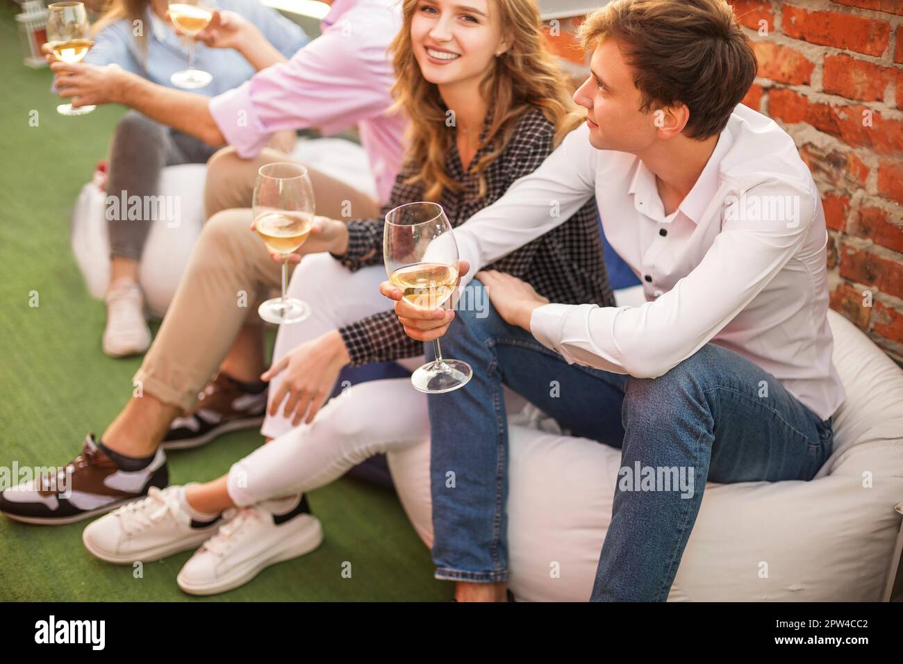 Happy man and woman with alcohol drinks smiling during meeting with ...