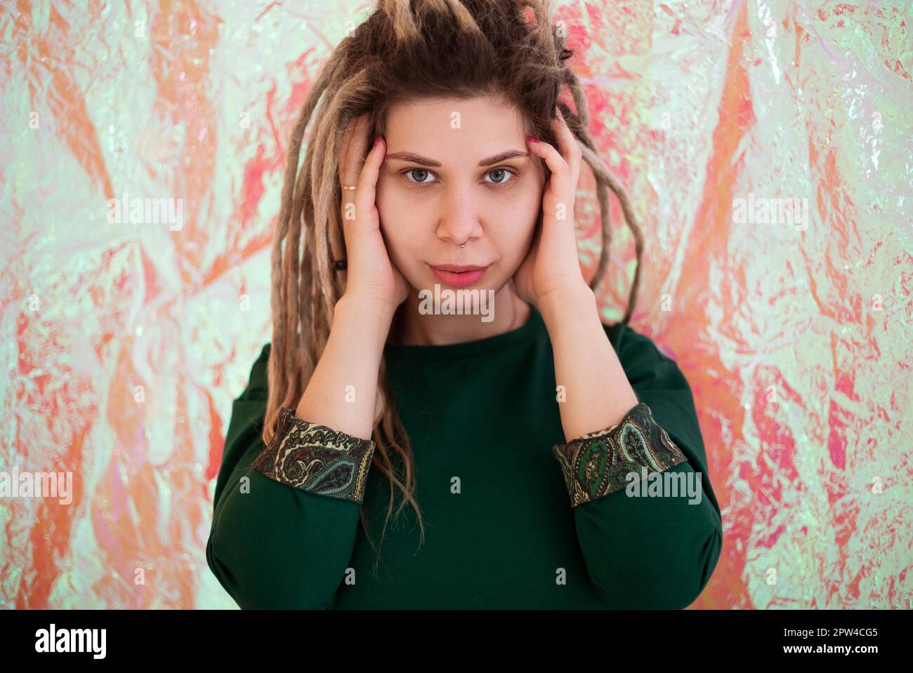 Cheerful young female in colorful outfit looking at camera with smile ...