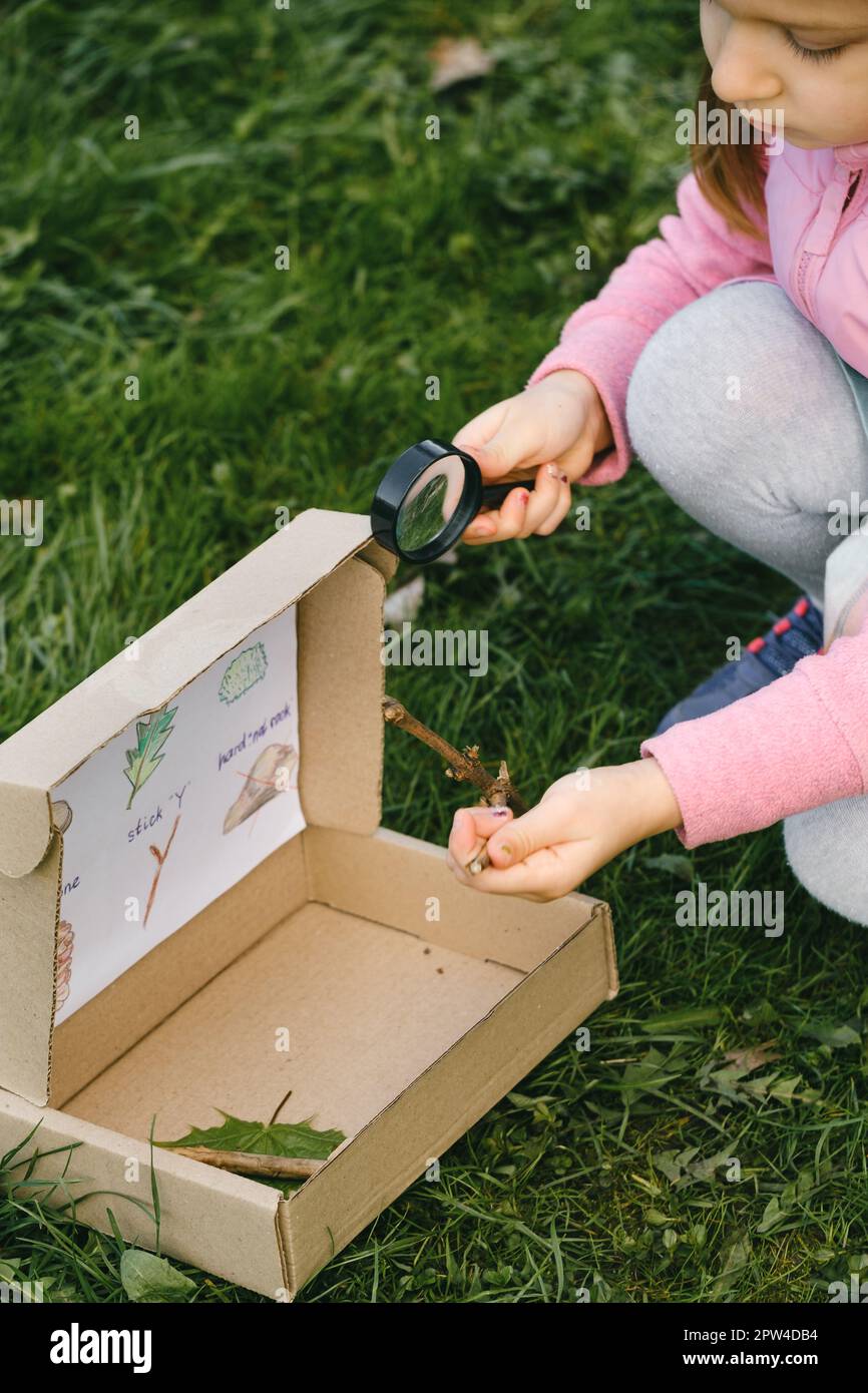 Scavenger hunt for kid in the park. Girl learning about environment ...