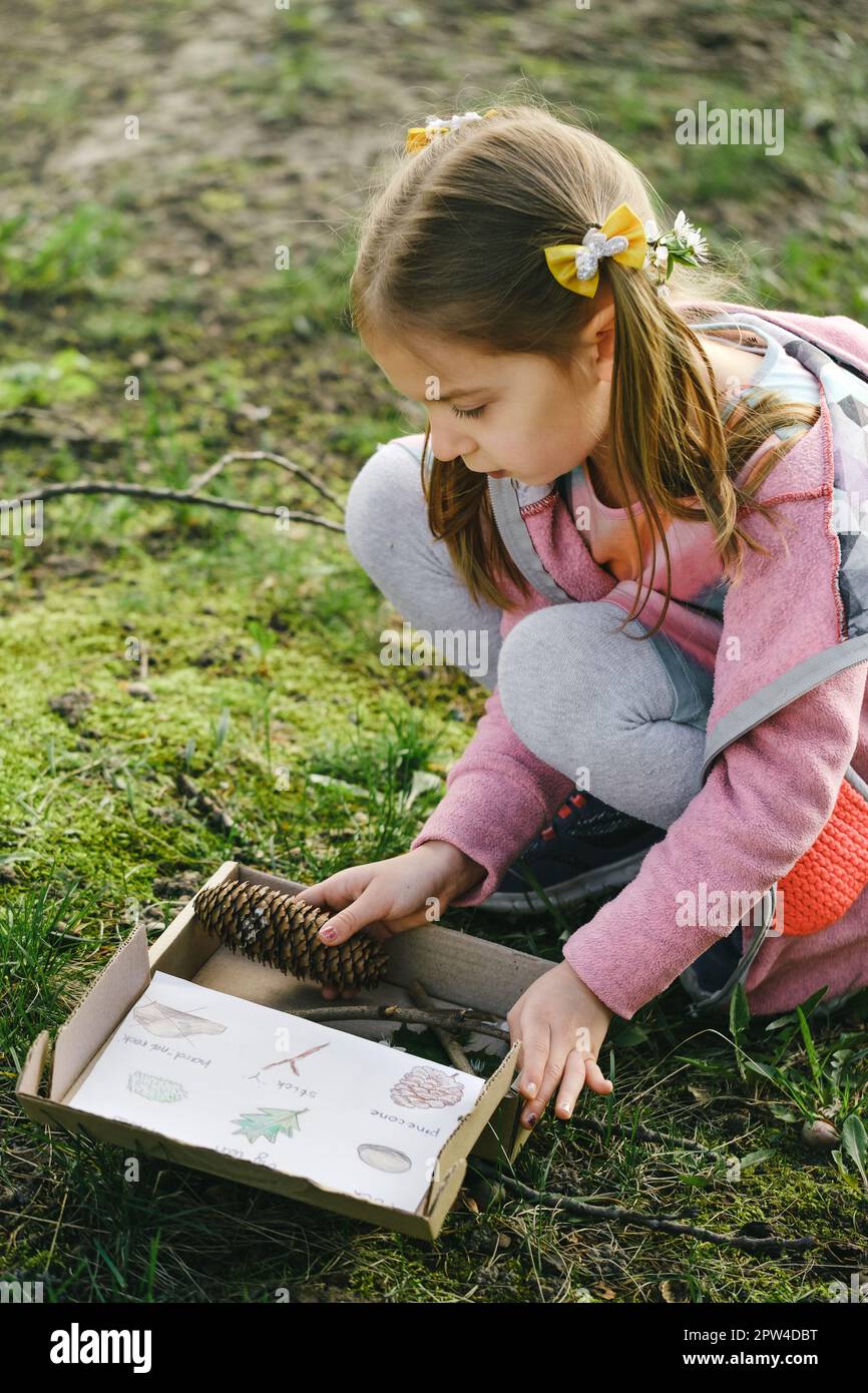 Scavenger hunt for kid in the park. Girl learning about environment ...