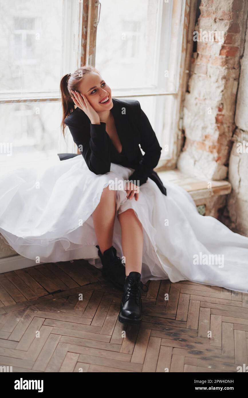 Full body cheerful female in trendy dress and jacket smiling and ...