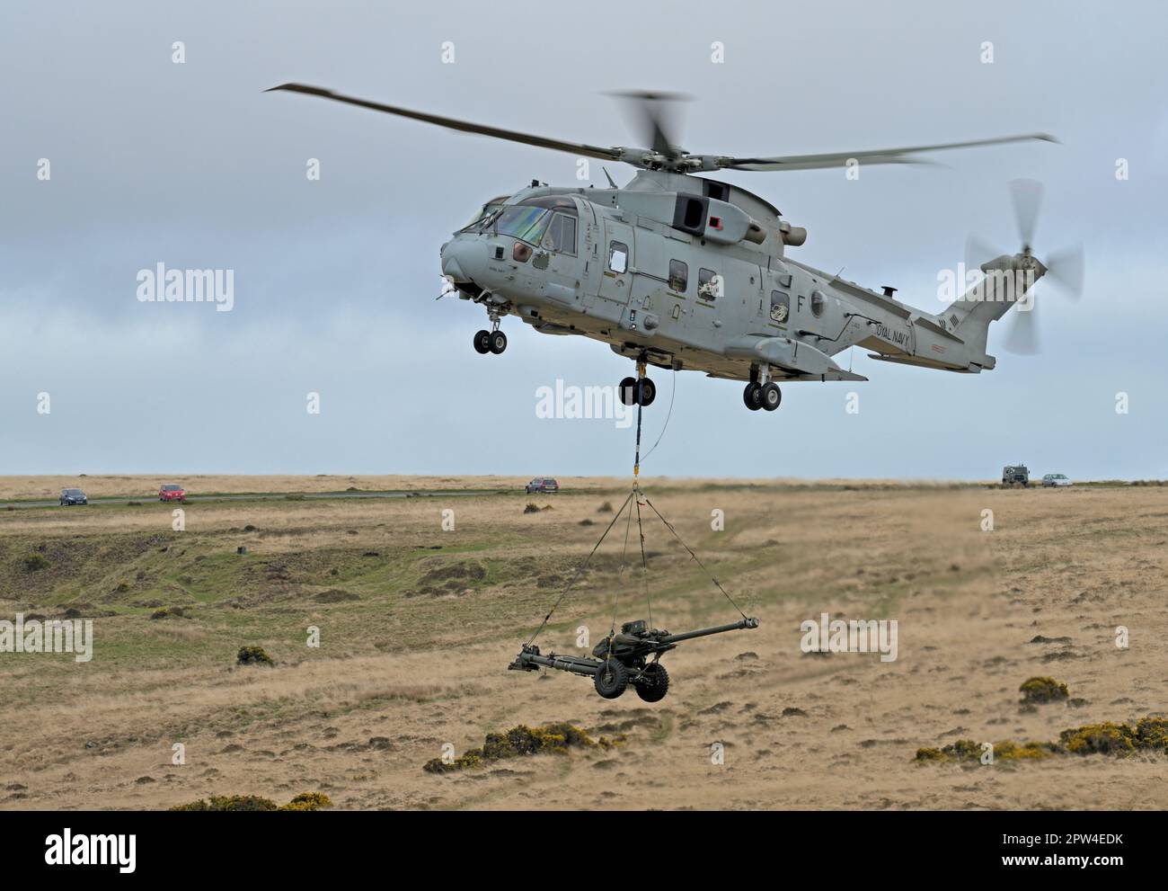 Royal Navy Merlin Commando Helicopter lifting start guns into position ...