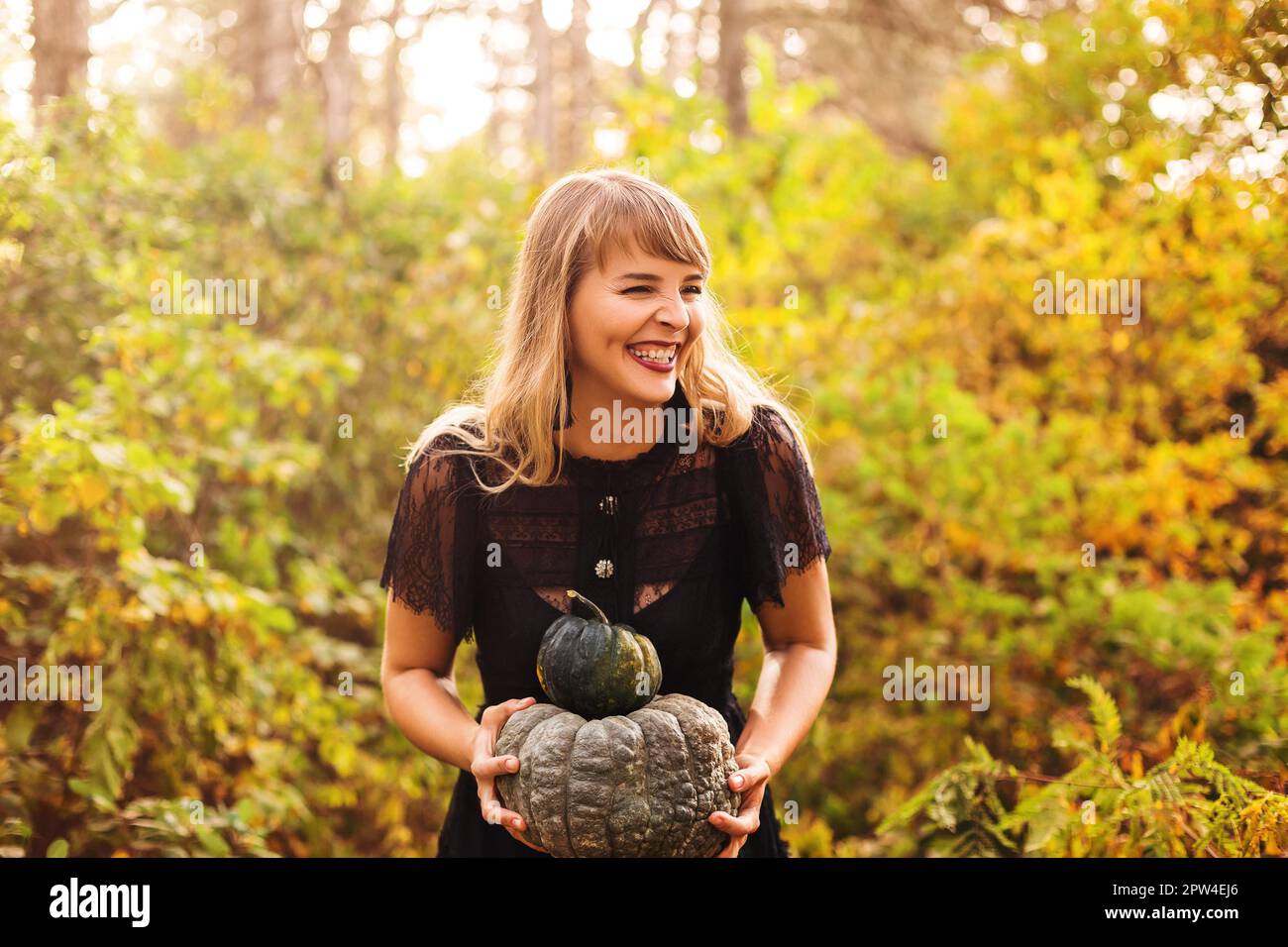 Portrait of beautiful happy young blond woman with long straight hair ...