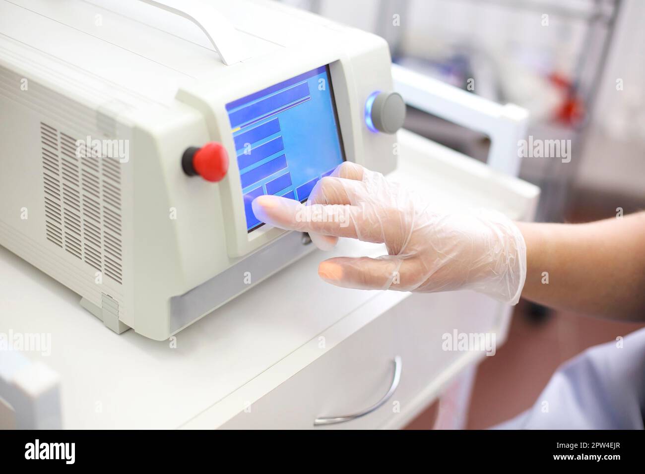 Hand of medical personnel worker in disposable glove pressing button on ...