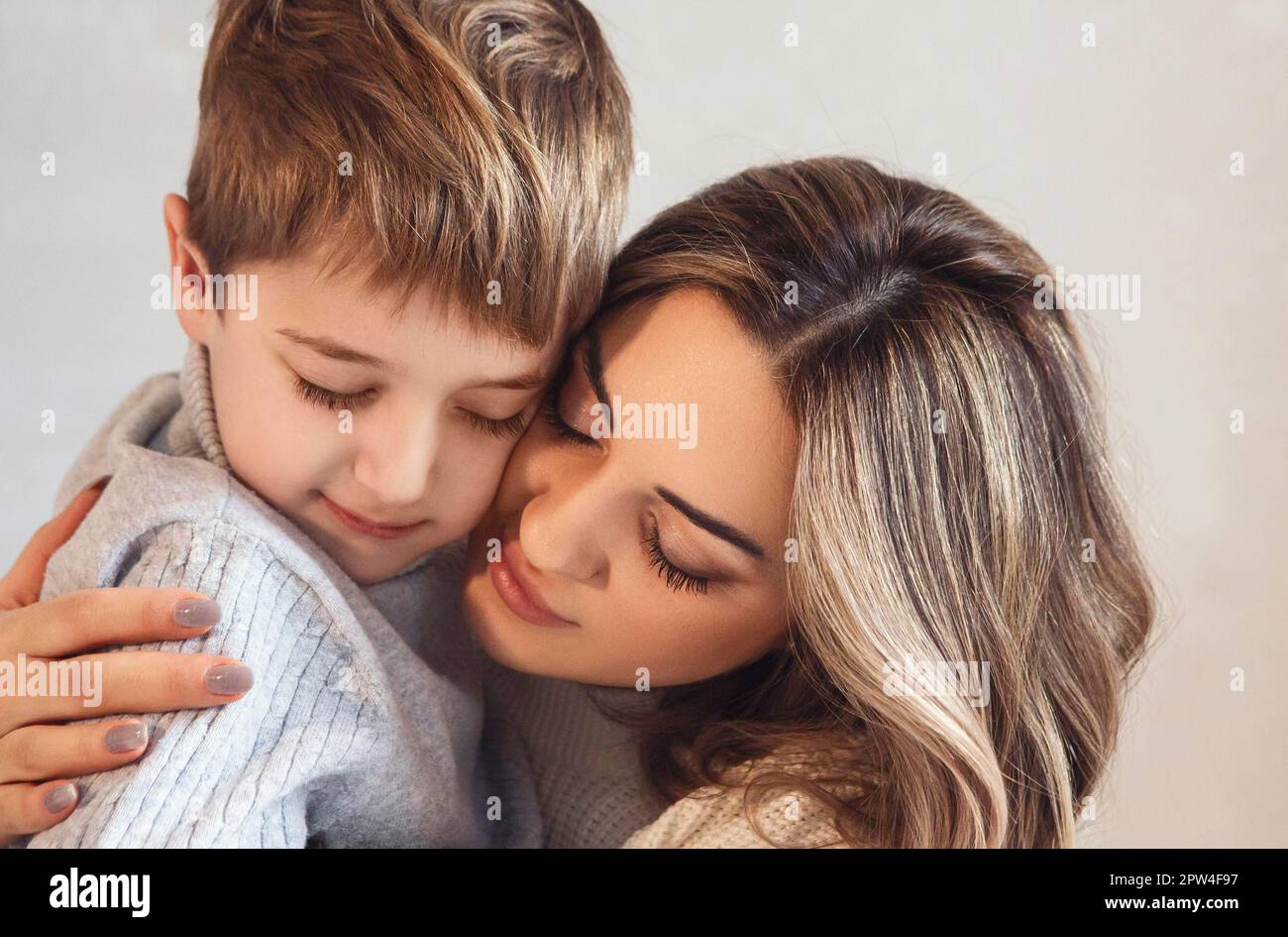 Raising Kids With Love. Cute family portrait of loving mother and ...