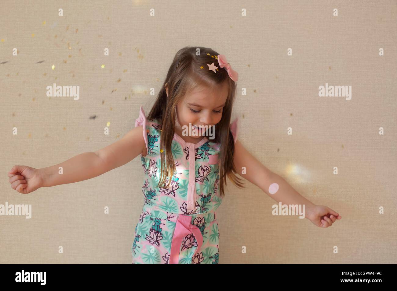 Happy childhood. Excited ecstatic cute adorable little girl throwing ...