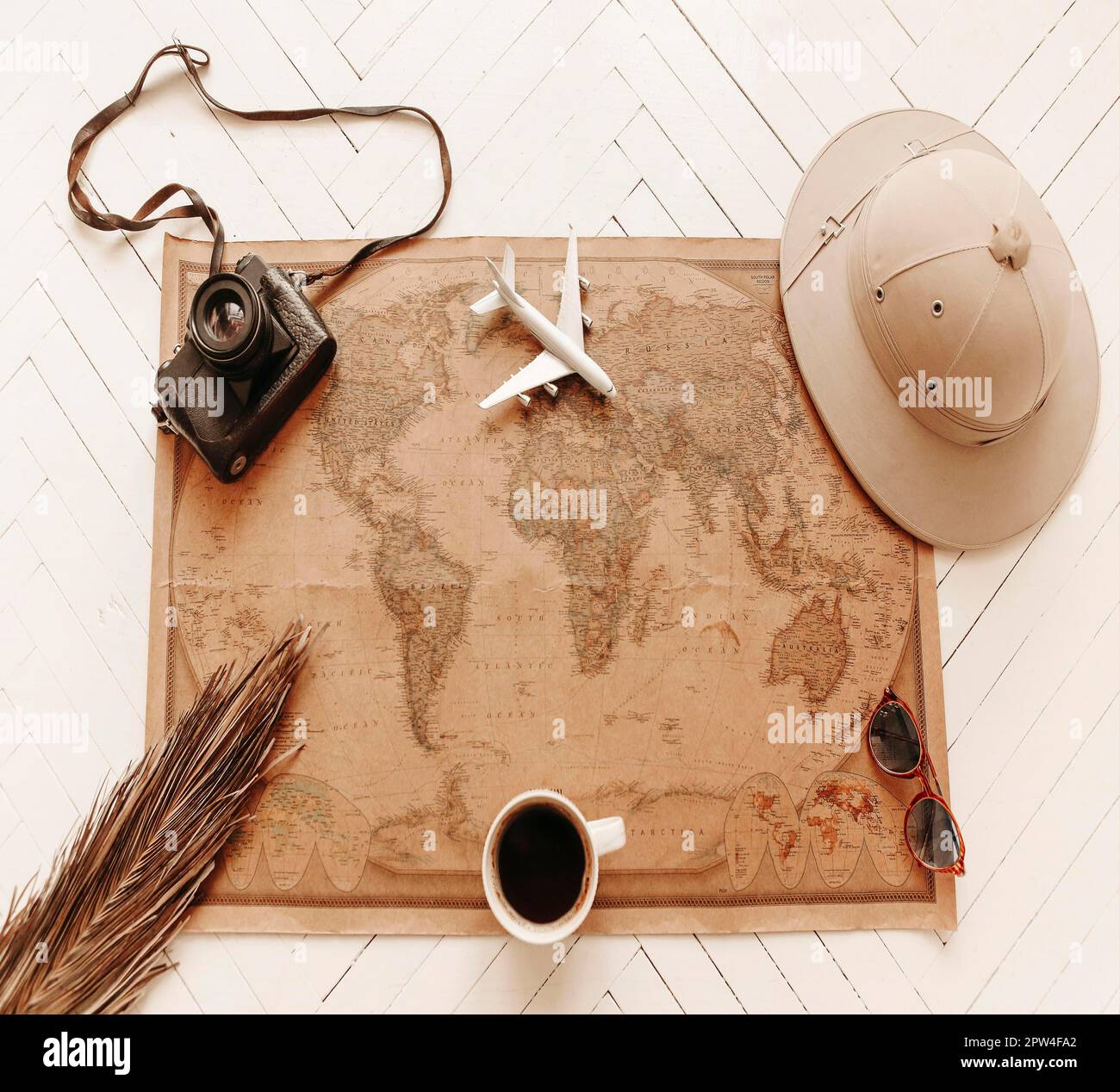 Top view of vintage world map with objects related to journey ...