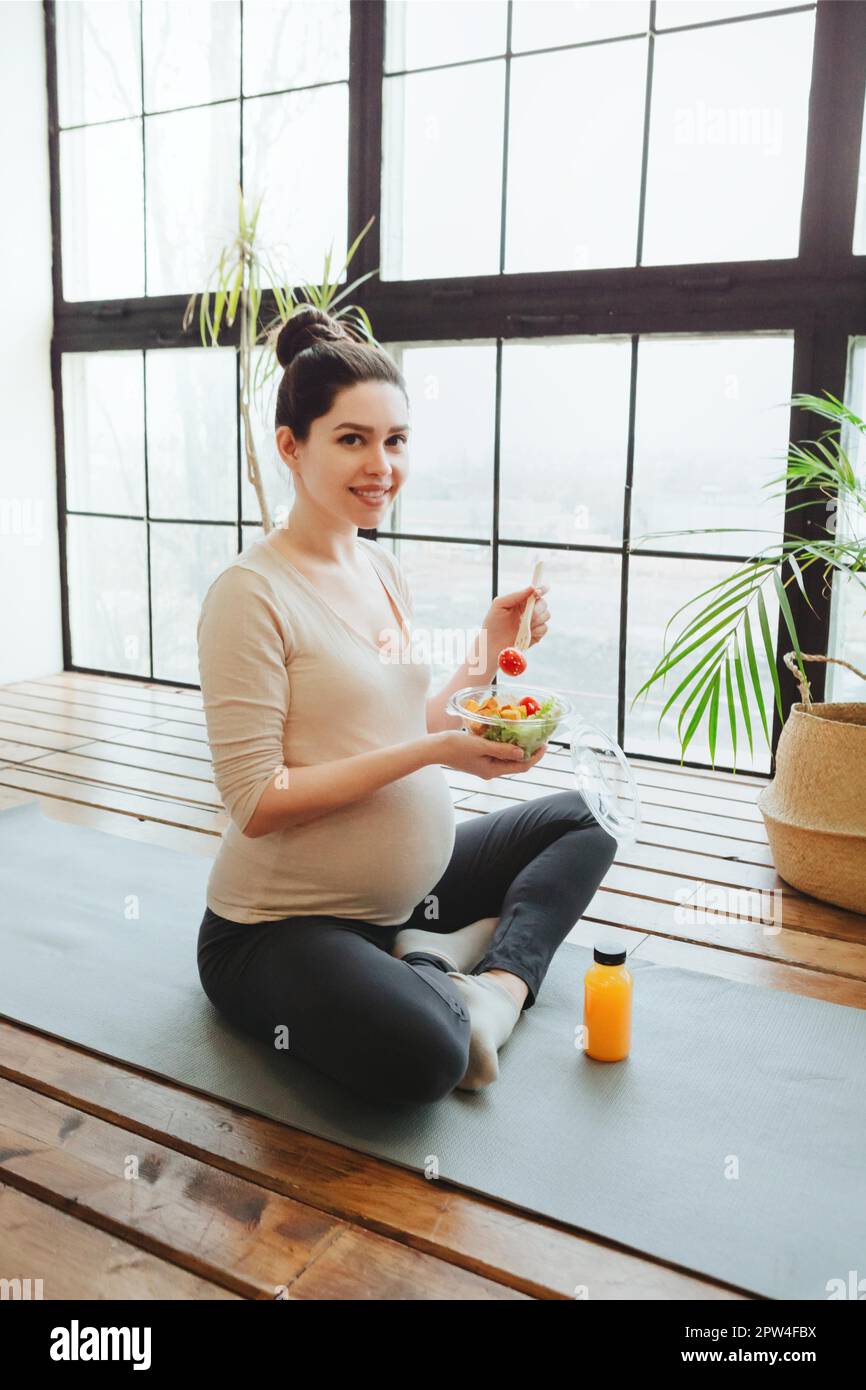 Healthy lifestyle and nutrition during pregnancy. Young happy beautiful ...