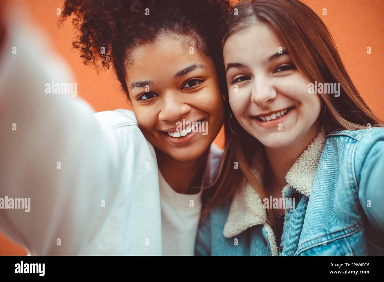 Self-portrait of two happy joyful teen girls of different races smiling ...