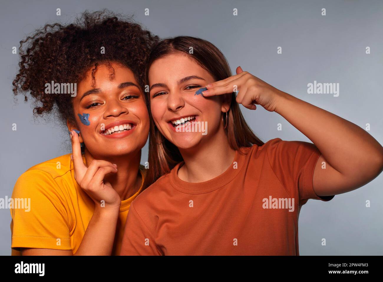 Spa day. Two happy multi-ethnic teen girlfriends having fun while ...