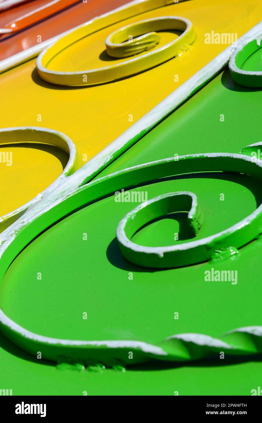 Metal texture of a piece of colored wall with a forged pattern. Rainbow ...