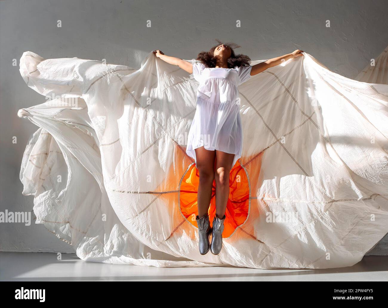 Jump and fly. Young overjoyed carefree african american woman jumping ...