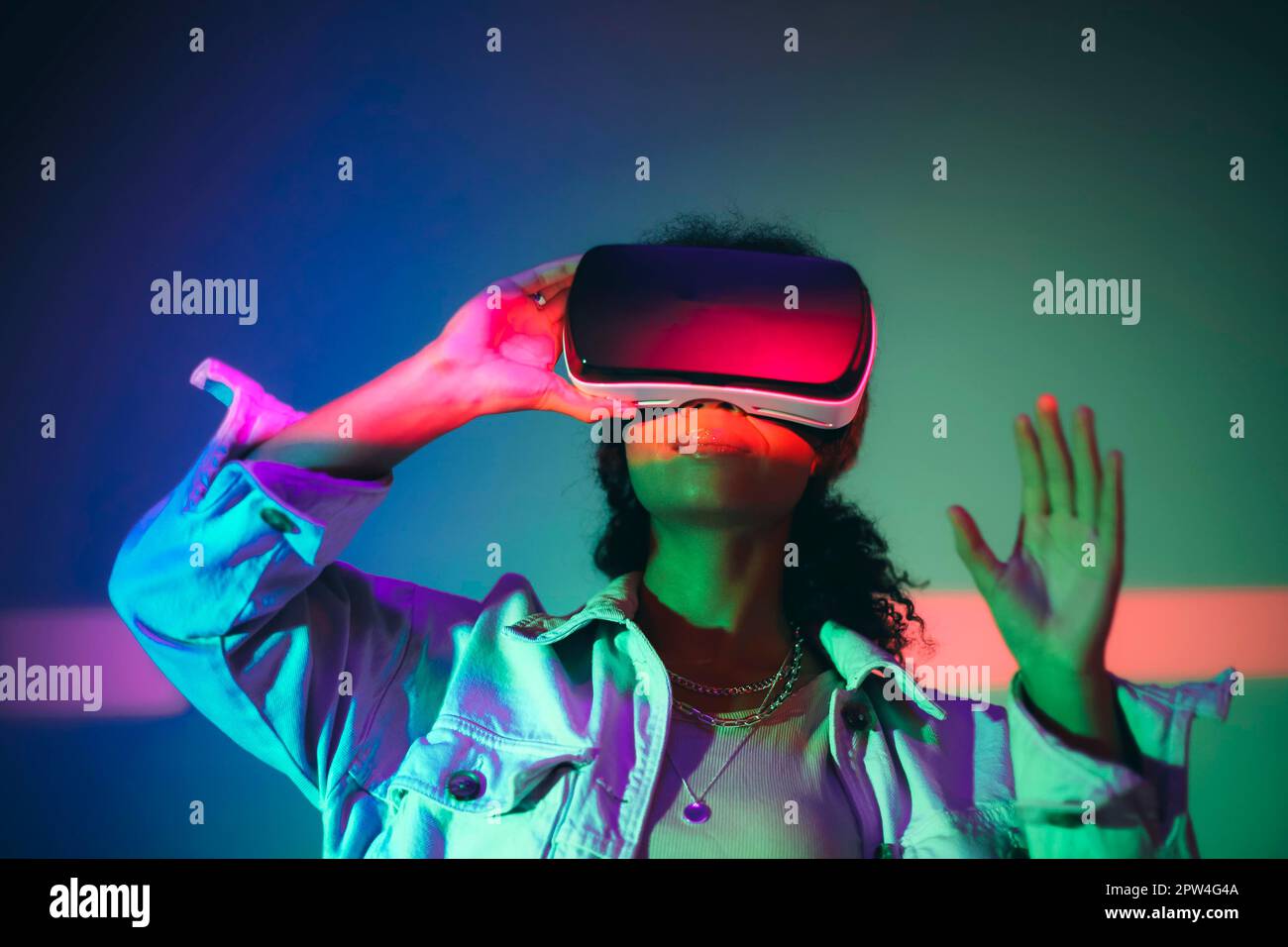 Virtual Reality. Young african american woman using VR headset goggles, interacting with ...
