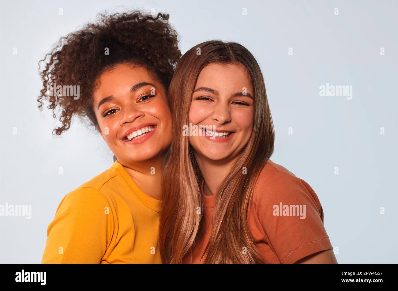 Positive multiracial teen girls, interracial best friends, standing ...